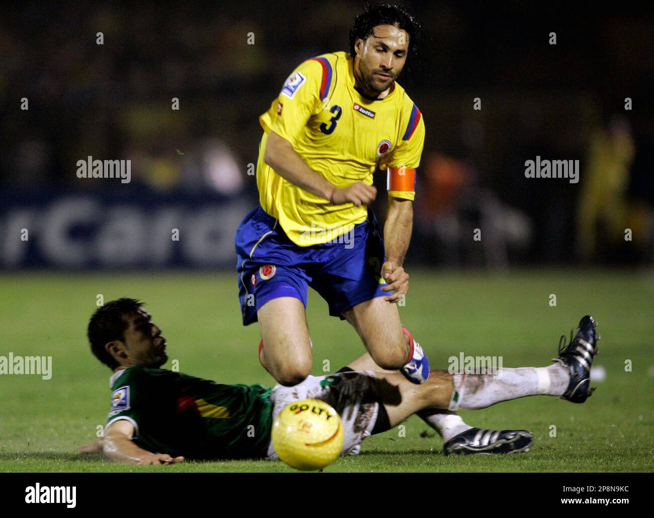Colombia's Mario Yepes, top, fights for the ball with Bolivia's Ronald ...