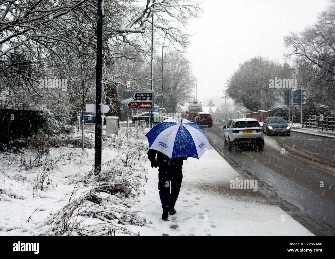 A man walking with umbrella in snowy weather, Birmingham Road, Warwick ...