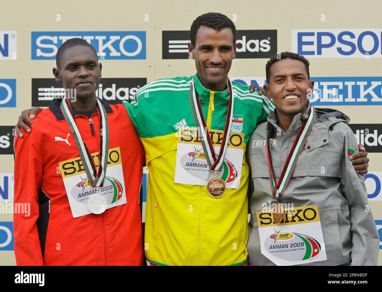 Gold medal winner Gebre-egziabher Gebremariam of Ethiopia, center, stands with silver medalist ...