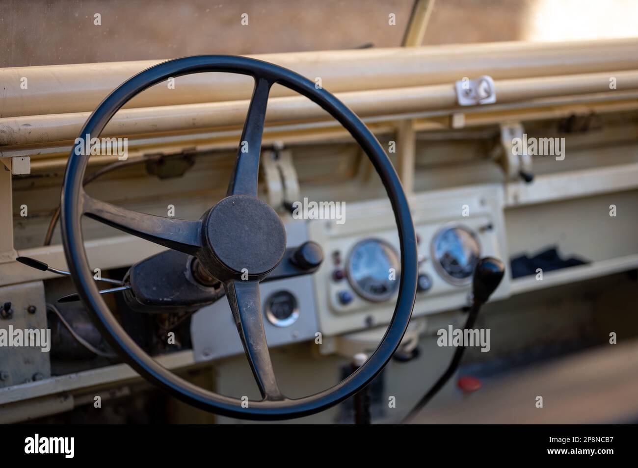 An interior shot of an vintage Land Rover, focusing on the steering ...