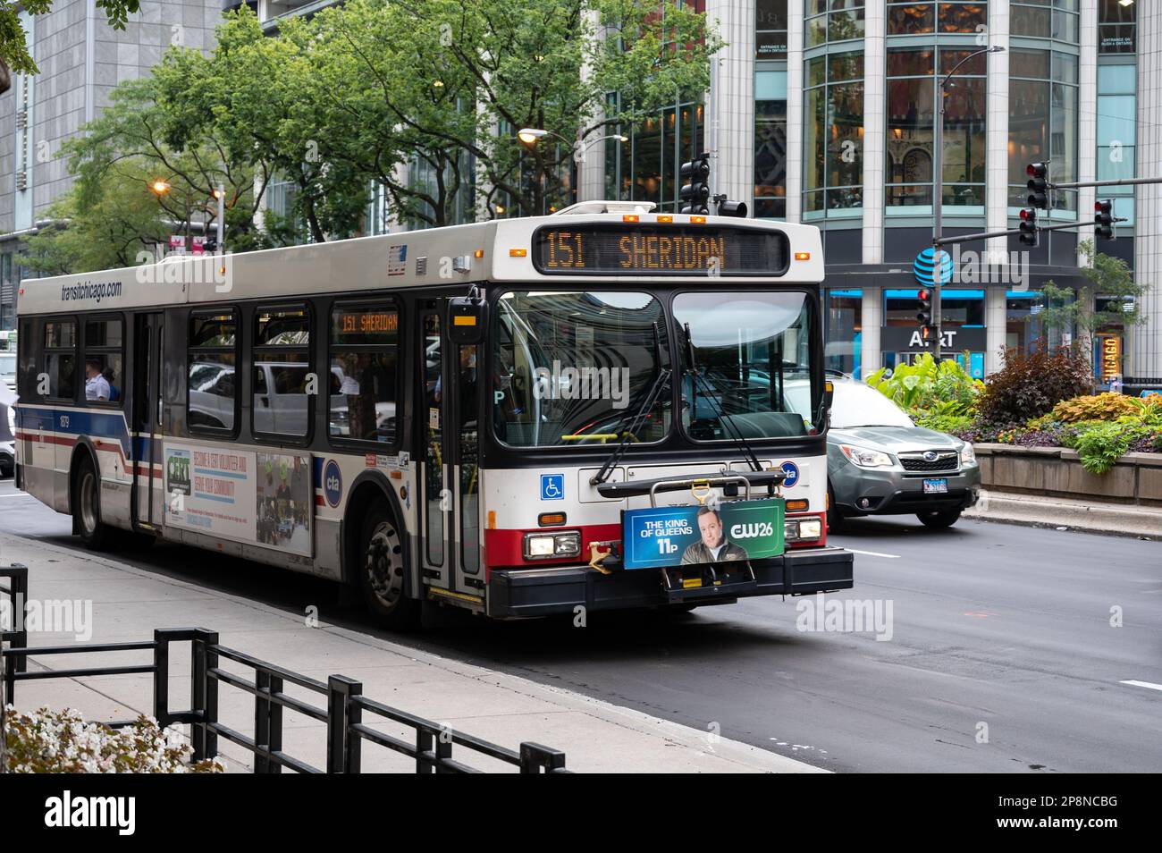 A public bus driving down a busy city street, with the "The King of ...