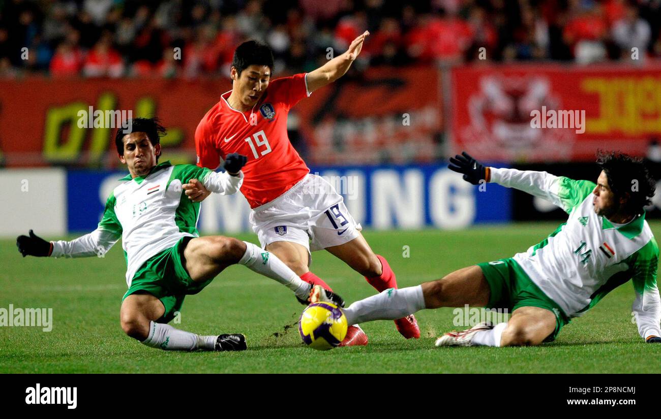 South Korea's Lee Keun-ho, center, fights with Iraq's Ahmed Anwer, left, and Khaldon Mohammed ...