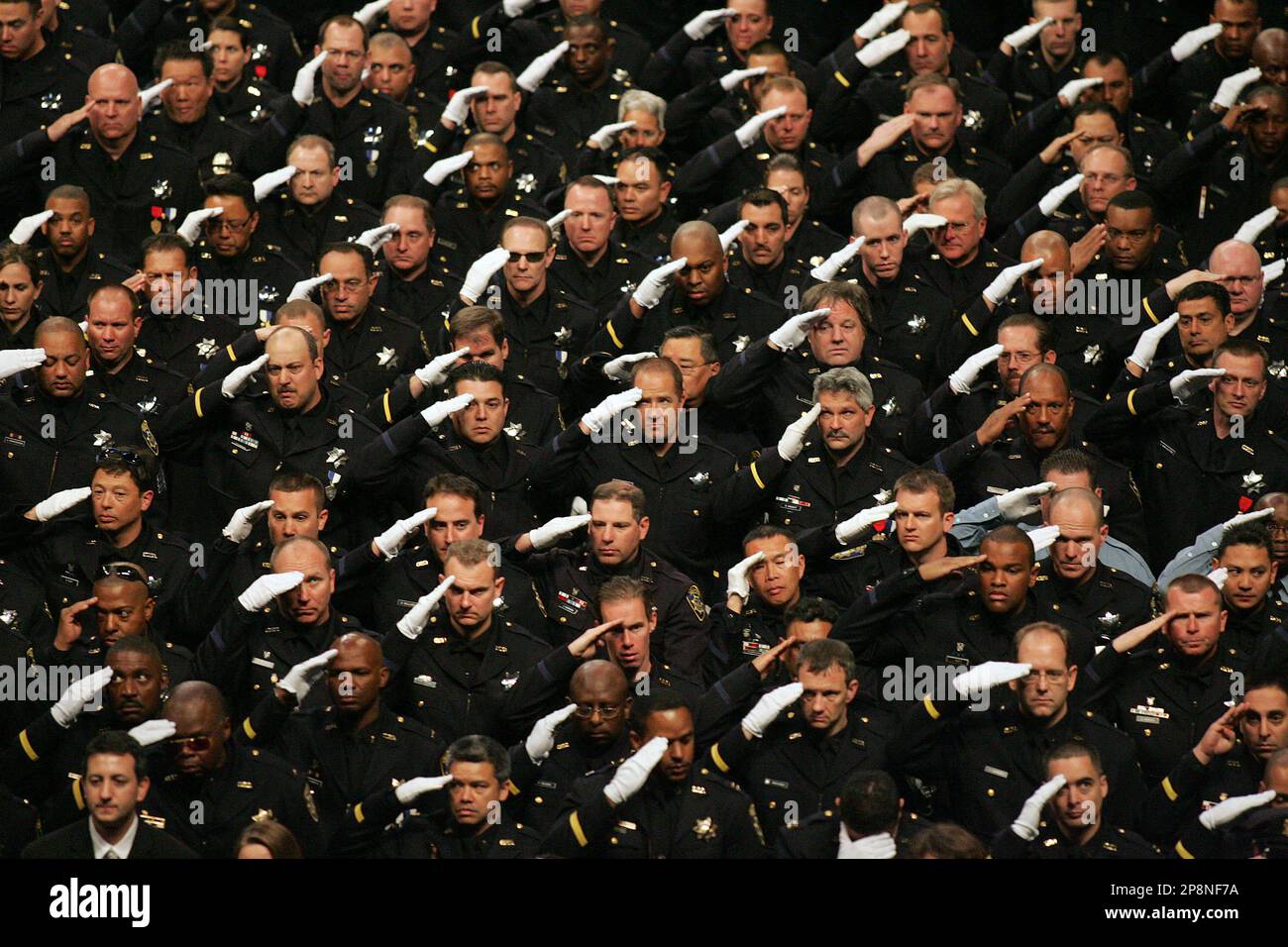 Oakland police officers salute as the caskets of Oakland Police ...