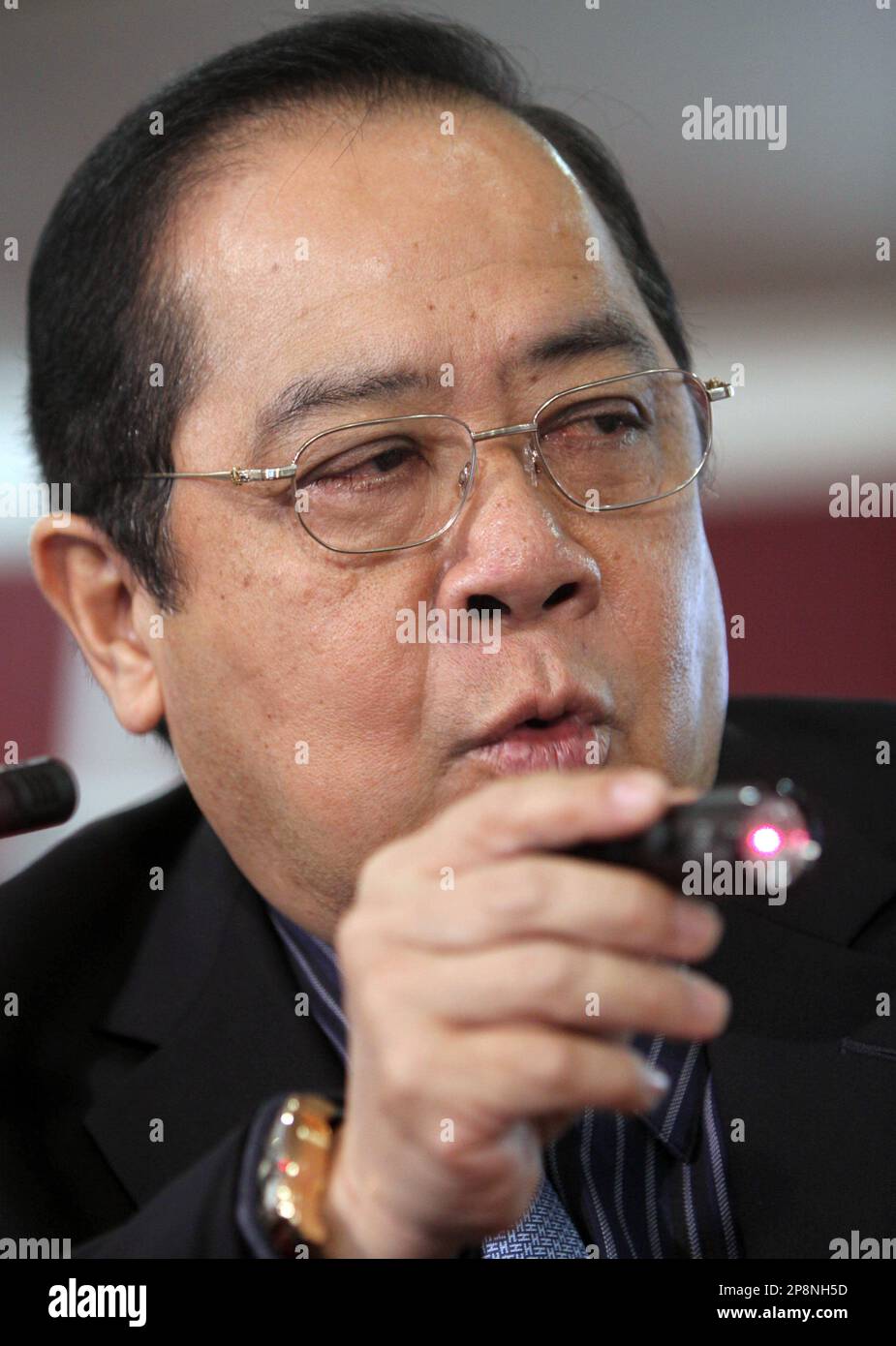 Philippine Interior and Local Government Secretary Ronaldo Puno uses a ...