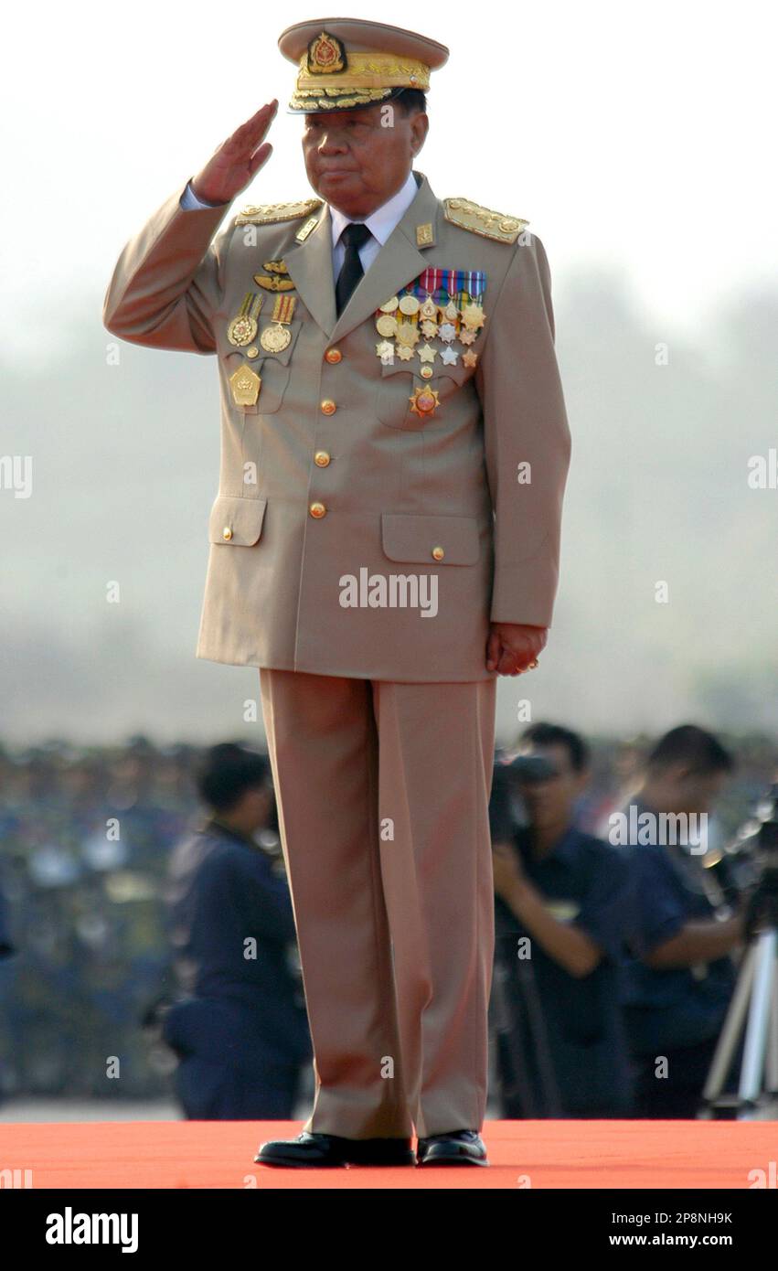 Myanmar's junta chief Senior Gen. Than Shwe salutes the national flag ...