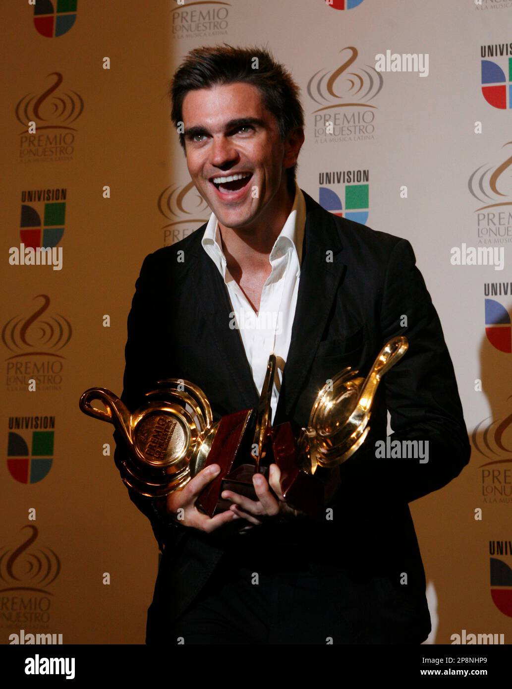 Colombian singer Juanes poses with his three awards backstage during ...