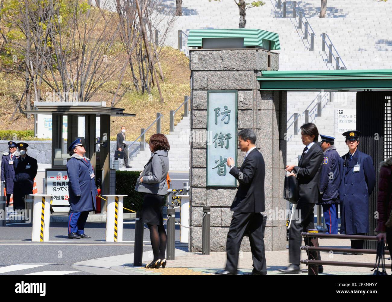 Security guards stand guard at the main gate of Japan's Defense ...
