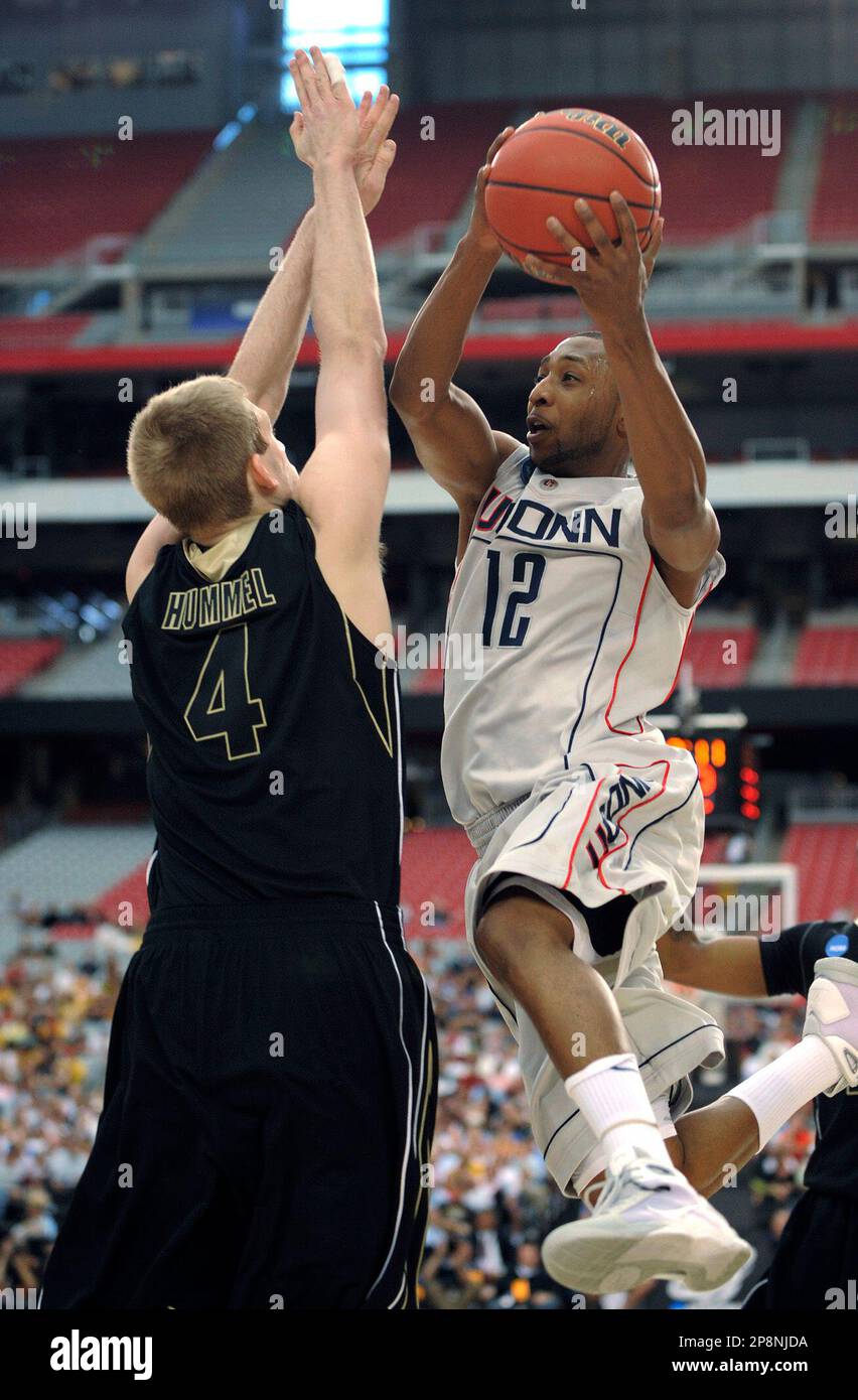 Connecticut's A.J. Price, right, drives to the basket against Purdue's ...