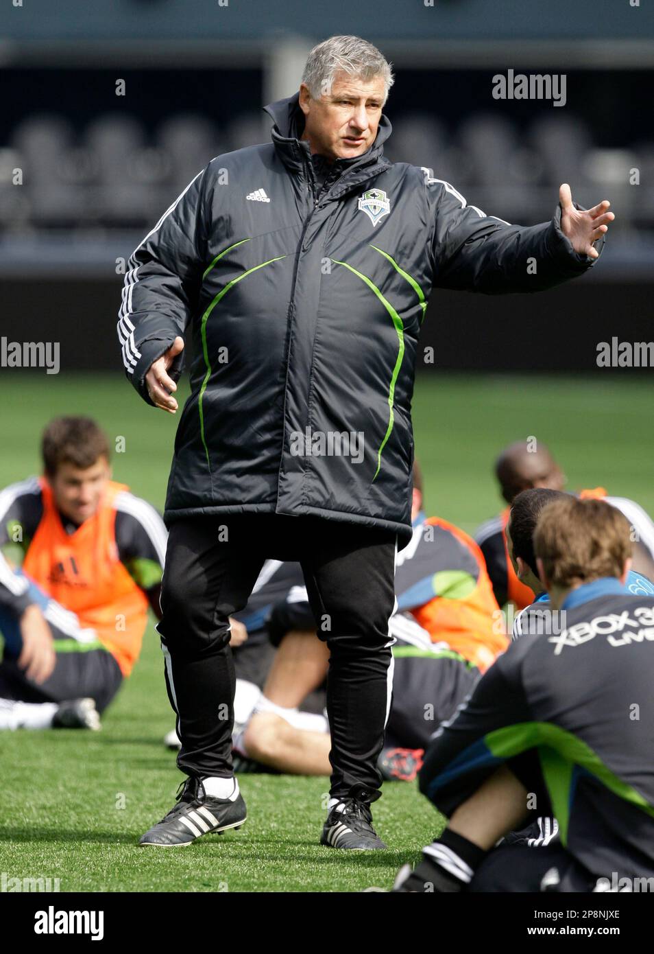 Seattle Sounders FC head coach Sigi Schmid talks with players as they ...