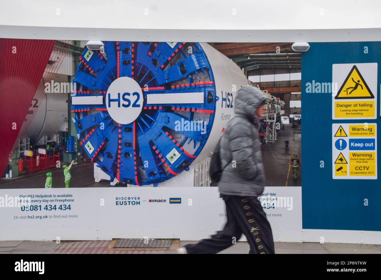 London, UK. 9th March 2023. A pedestrian walks past the signs at the ...