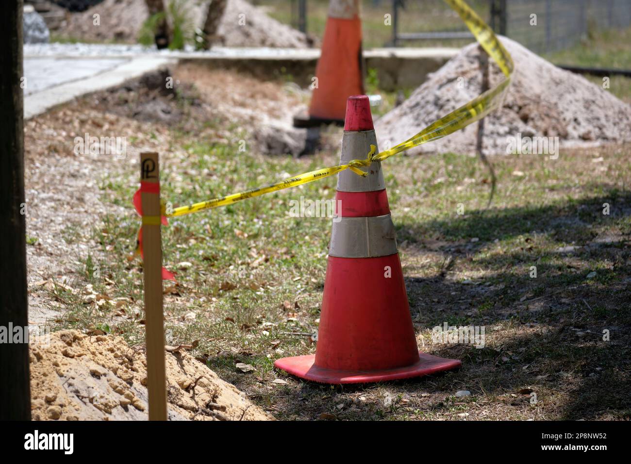 Yellow warning cones and tape as protective restriction barrier at ...