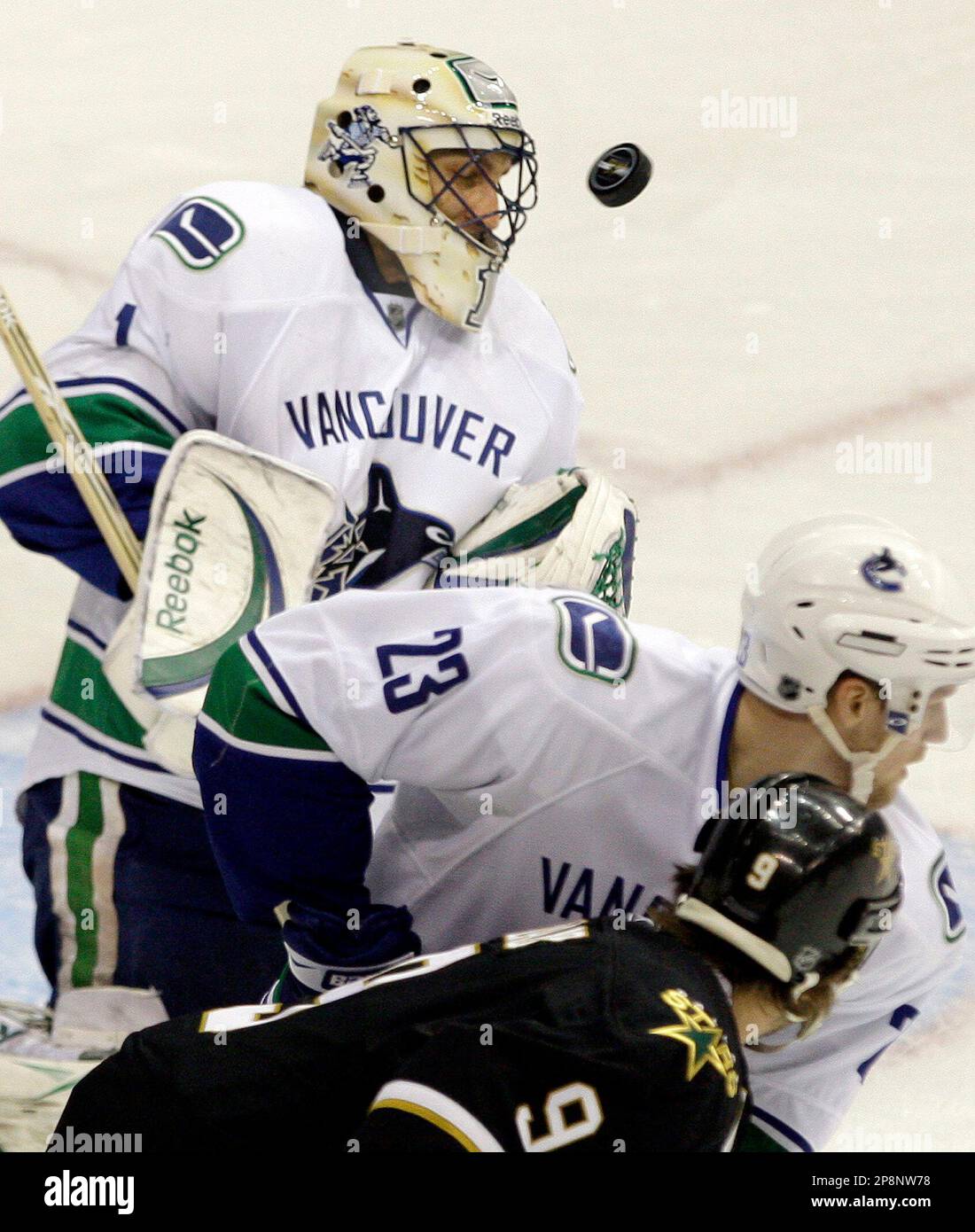 Vancouver Canucks goalie Roberto Luongo (1) deflects the puck as ...