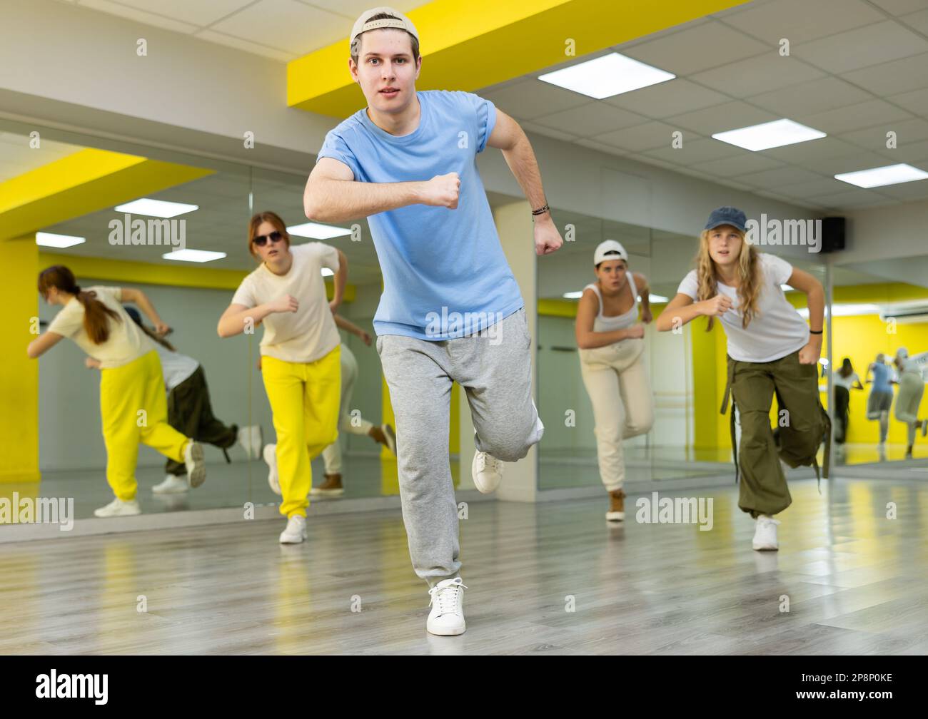 Teenage boy training breakdance Toprock moves in dance hall Stock Photo ...