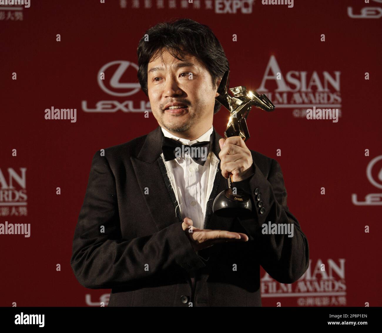 Japanese director Hirokazu Kore-Eda celebrates with the trophy after ...