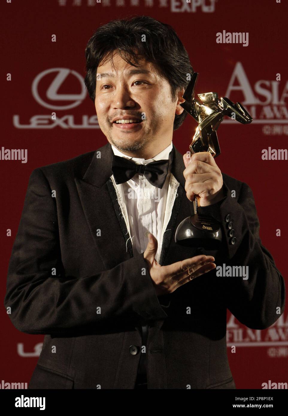 Japanese director Hirokazu Kore-Eda celebrates with the trophy after ...