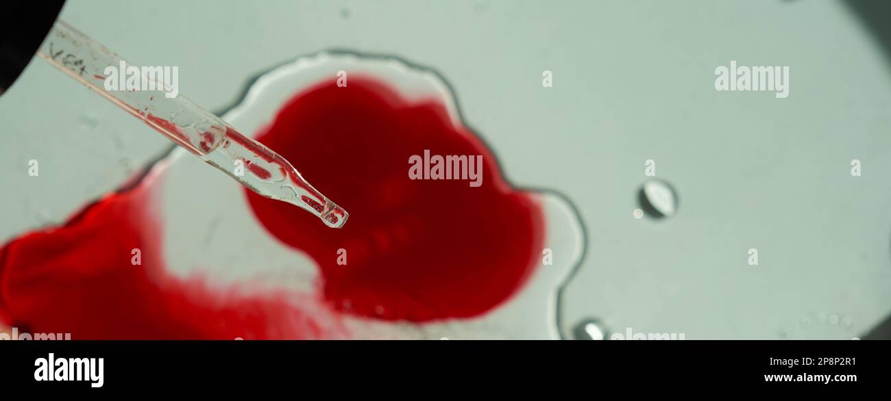 Banner. Red liquid with a pipette in the form of a spot in the ...