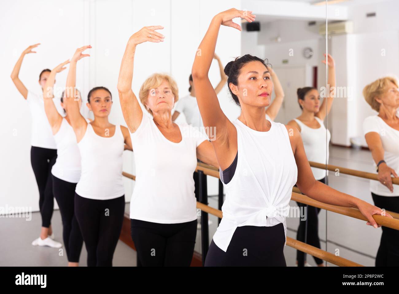 Group of women engaged in ballet standing in the 3rd position of the ...