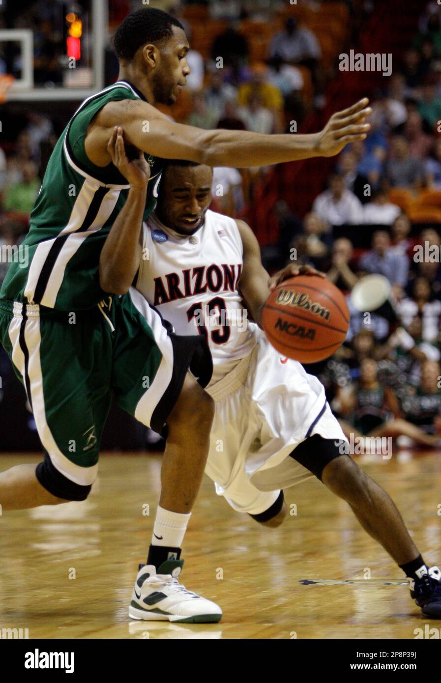 Arizona's Nic Wise (13) attempts to pass Cleveland State's George Tandy ...