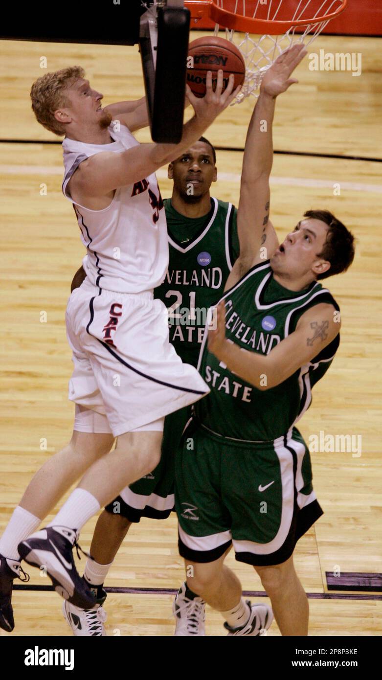 Arizona's Chase Budinger, left, goes for a basket as Cleveland State's ...