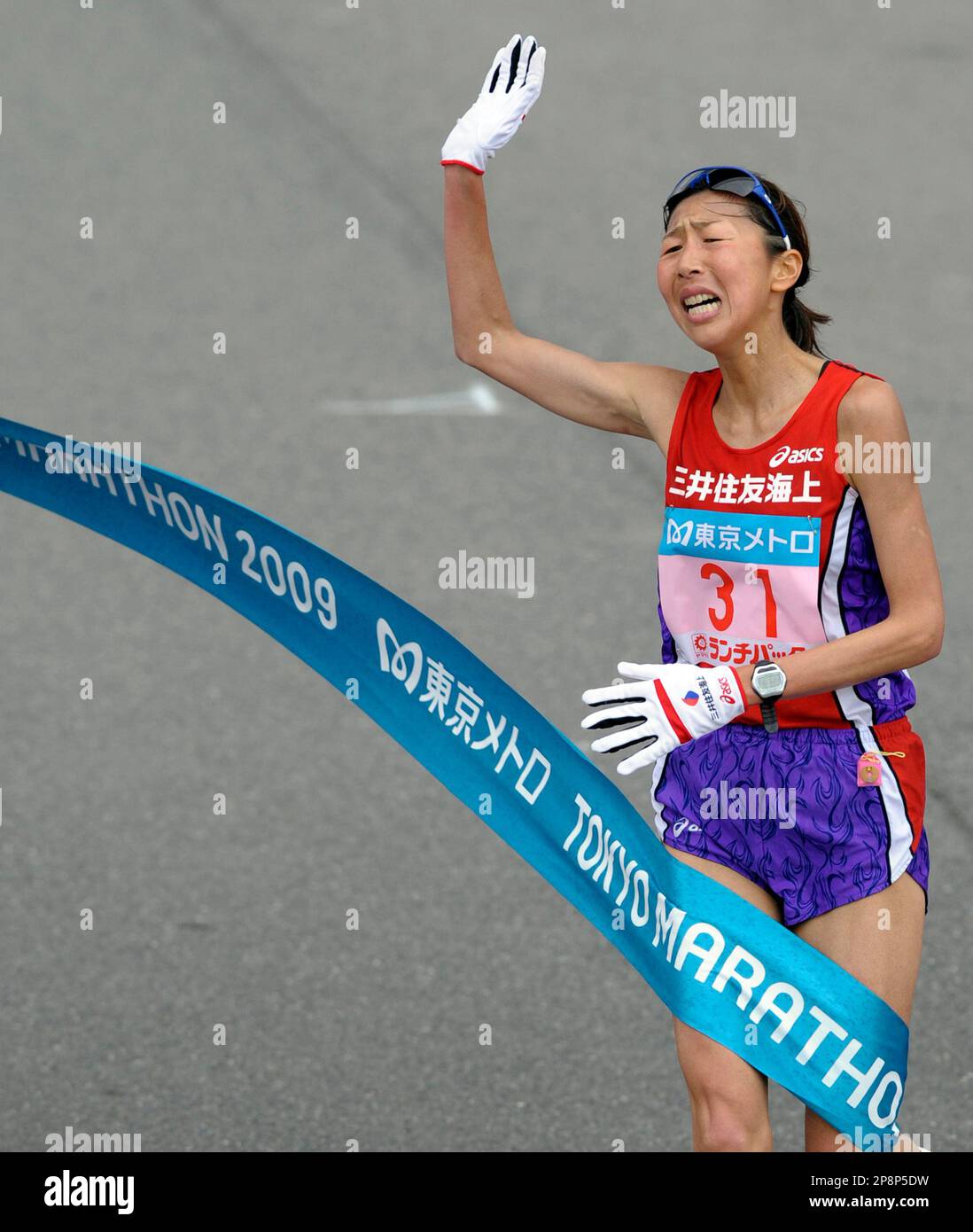 Japan's Reiko Tosa crosses the finish line of her career's final race ...