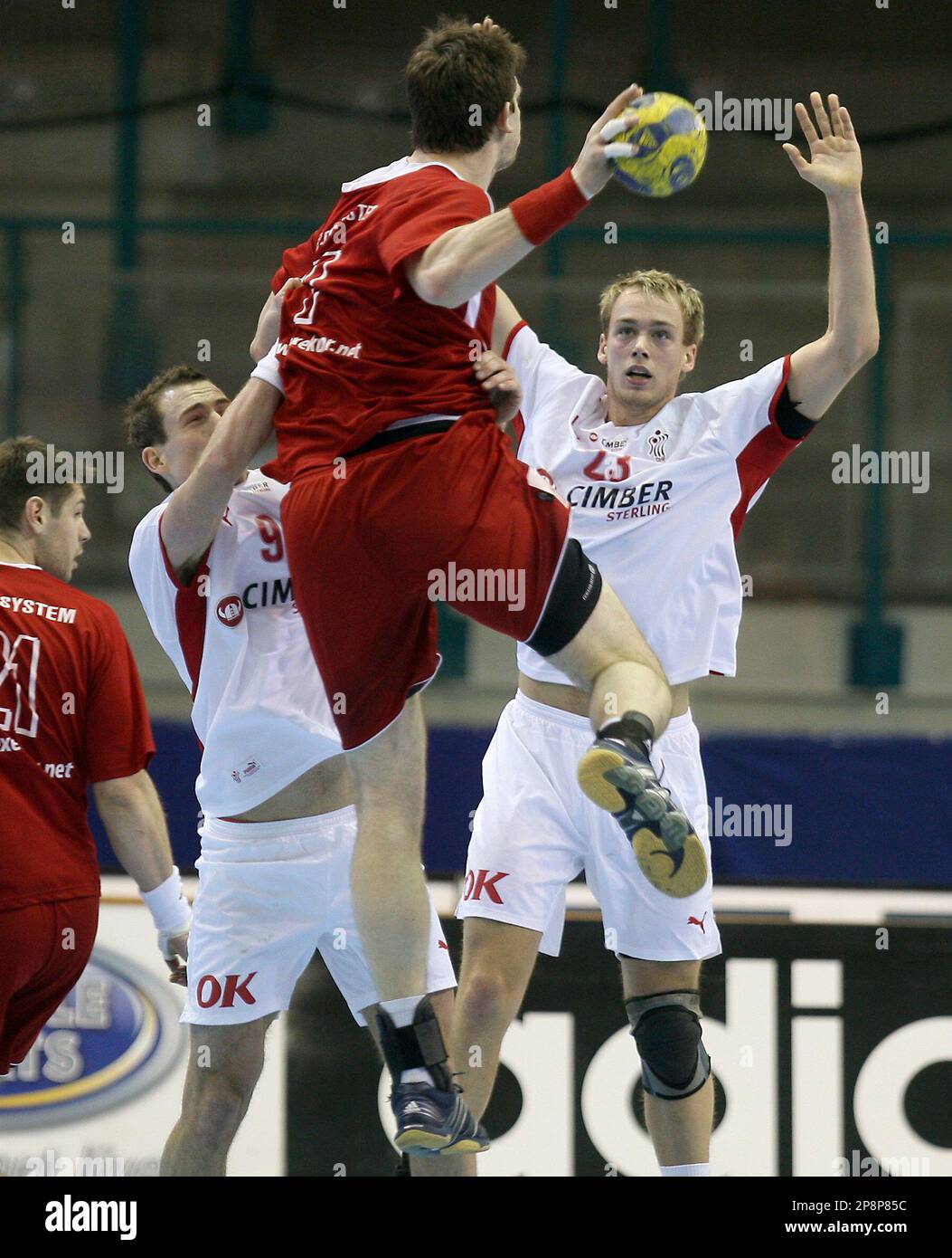 Daniel Kubes of Czech Republic, center, shoots through Denmark's Mads ...