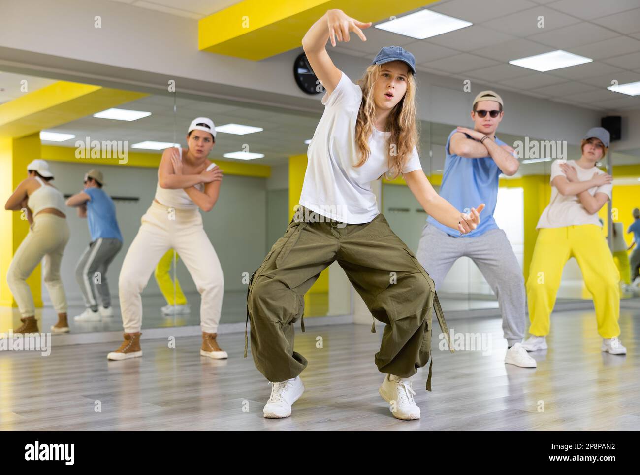 Teen girl in cap dancing modern dances Stock Photo - Alamy