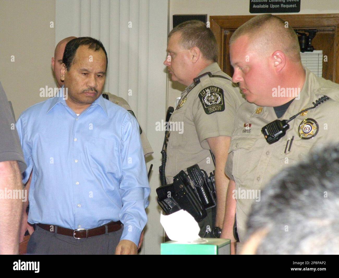 Eiken Elam Saimon is led from Judge Timothy Perigo's Newton County ...