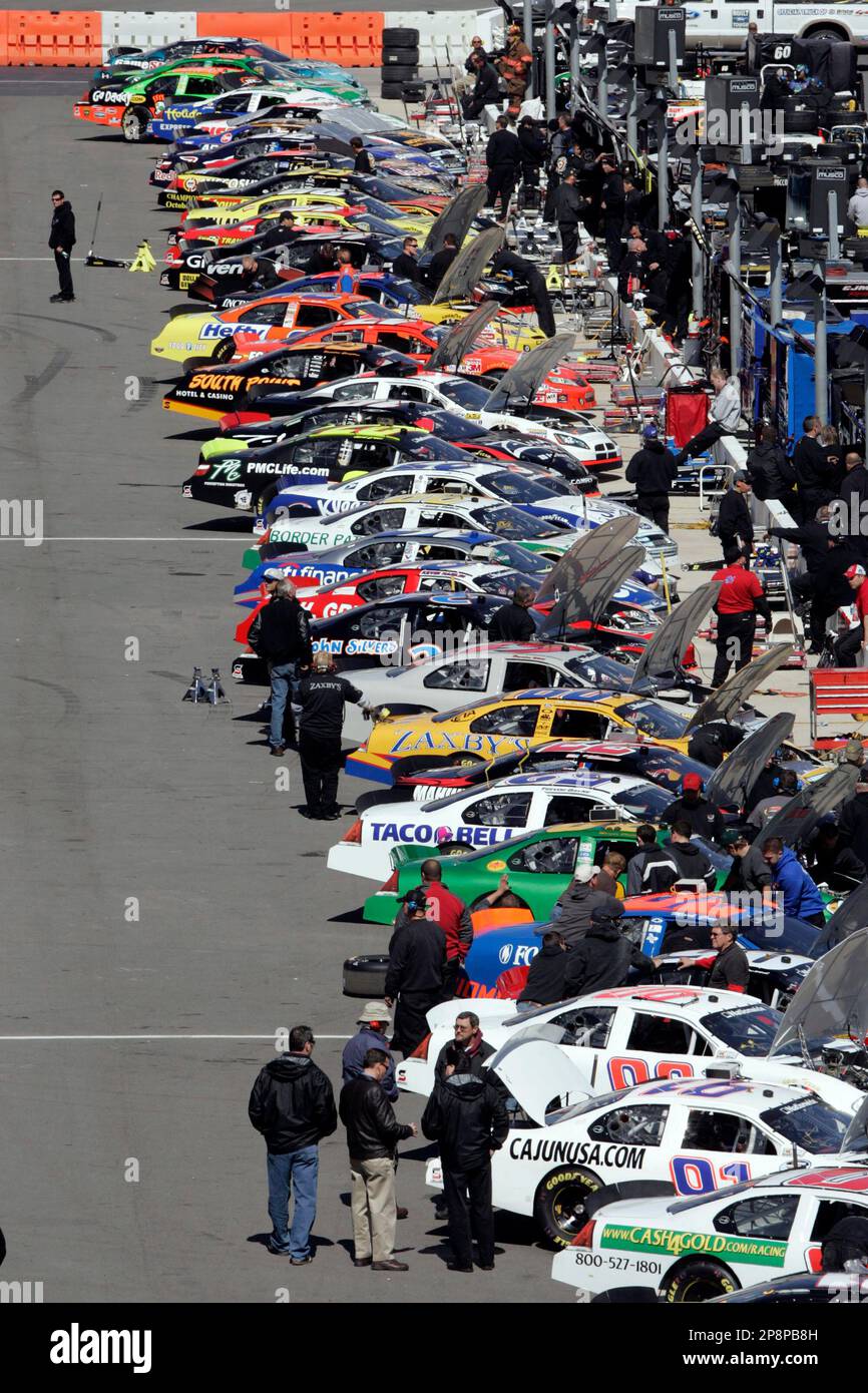 The NASCAR Nationwide Series cars are line up along pit row before the ...