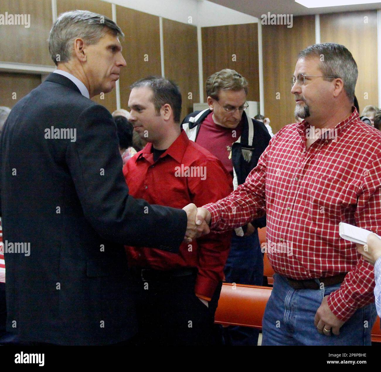 Kansas Assistant Attorney General Vic Braden, left, shakes hands with ...