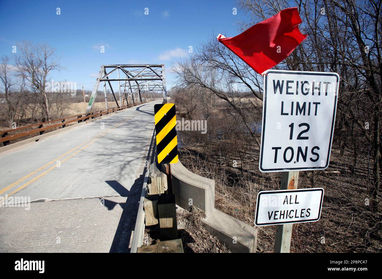 A weight limit sign stands near a 60-year-old bridge spanning the ...