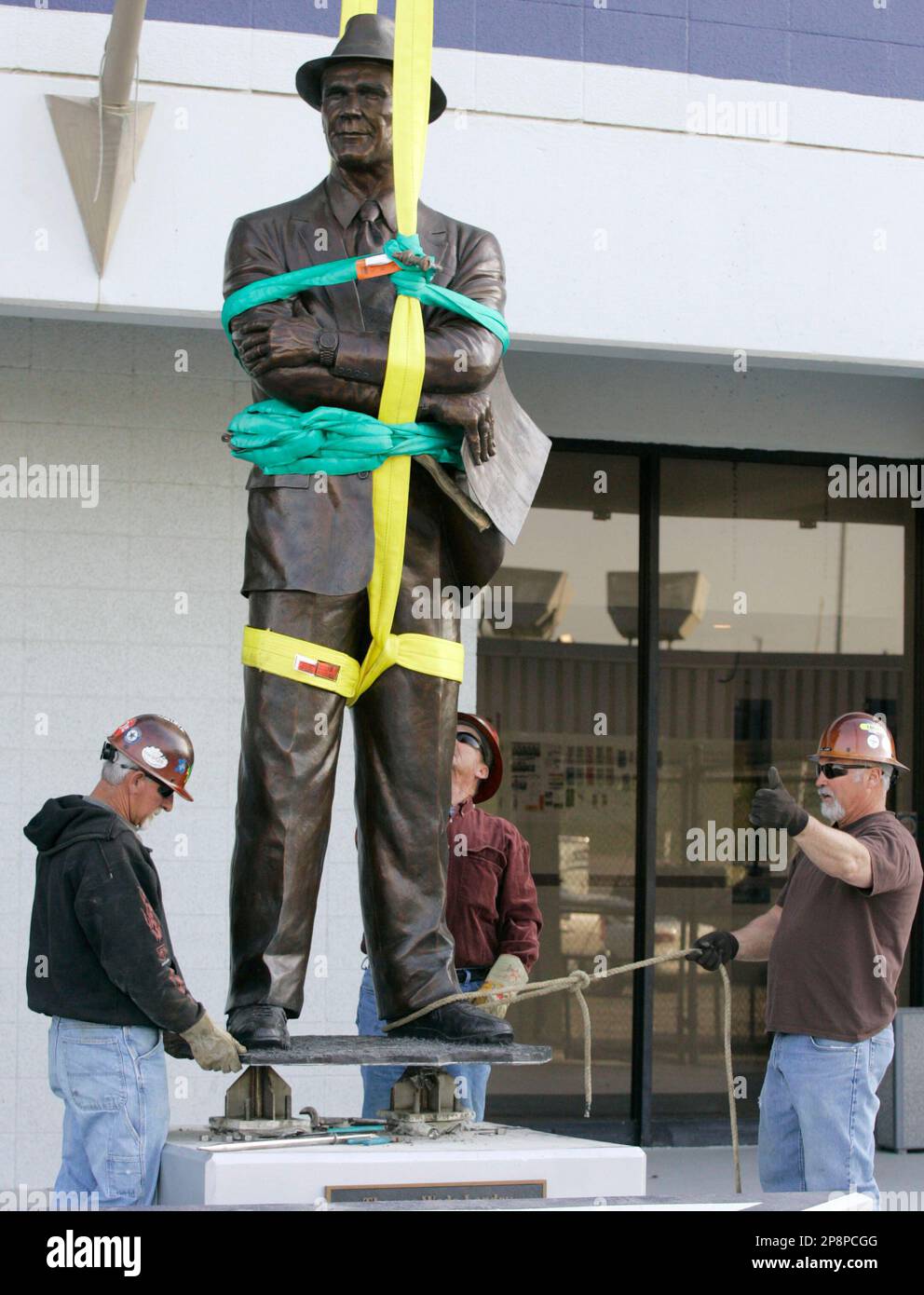 Workers Bill Garbers, left, Jack Melton, back and Mike Jump remove the ...