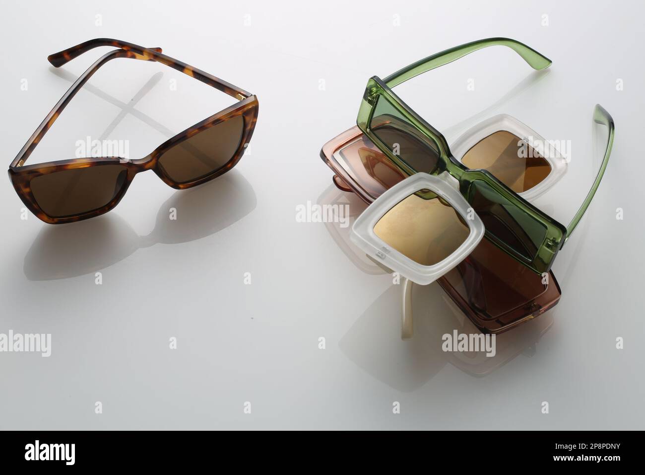 Stack of colourful sunglasses hi-res stock photography and images - Alamy