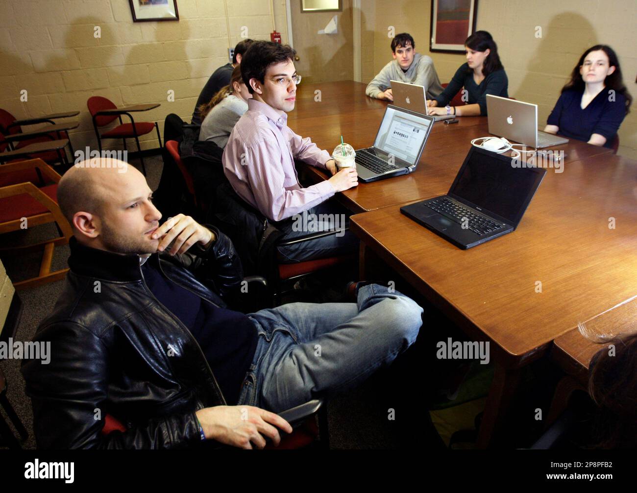 Greg Epstein, far left, the humanist chaplain at Harvard University, listens to students during ...