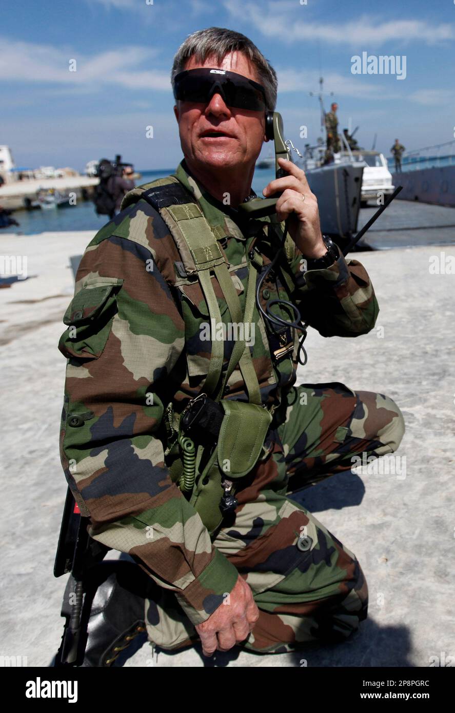 A French soldier talks on his radio, during a joint exercise called ...