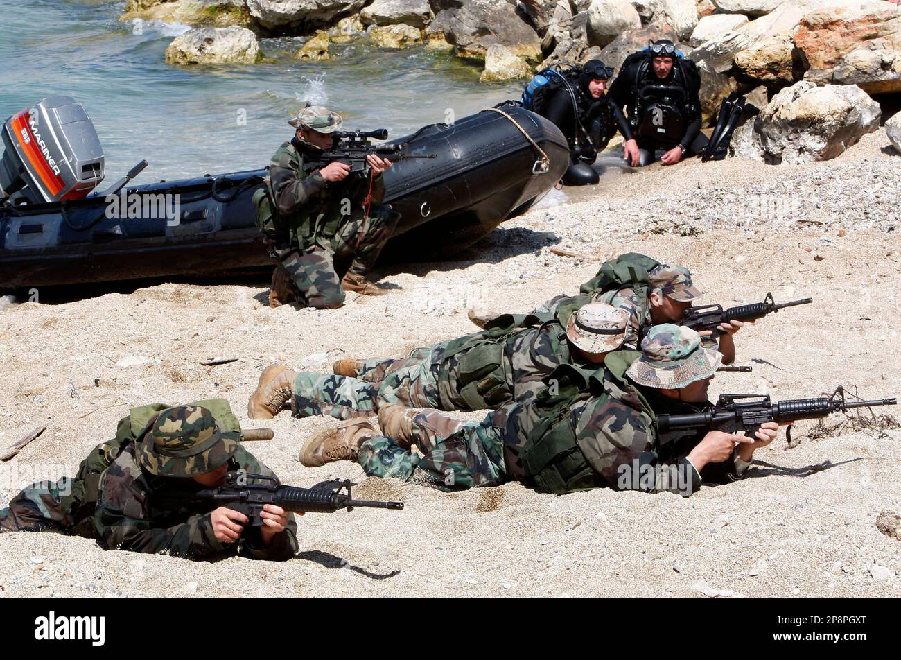 Lebanese marine special forces take their positions on the beach as two ...