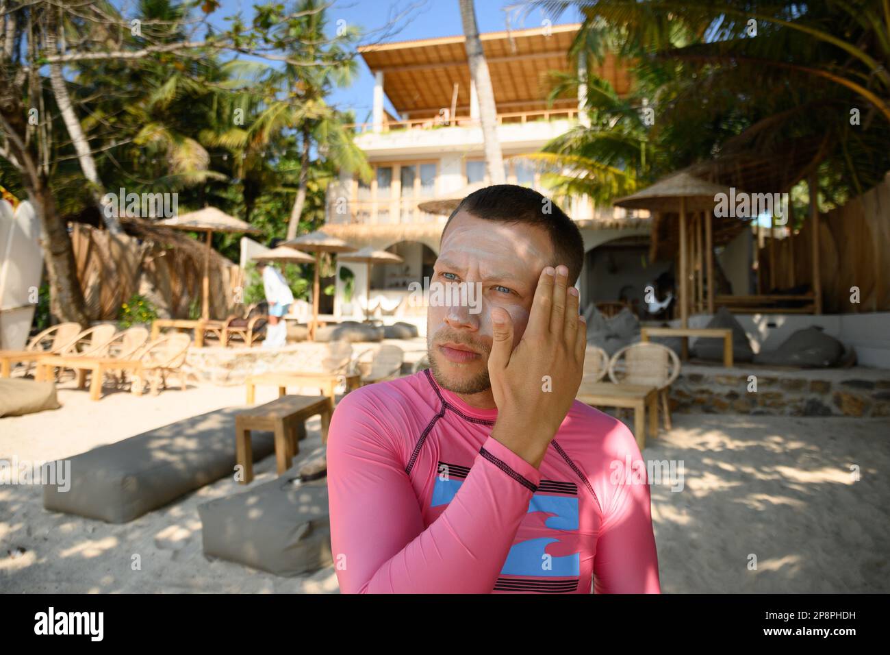 Man surfer applies protective zinc on face. Preparing to surf. Best ...