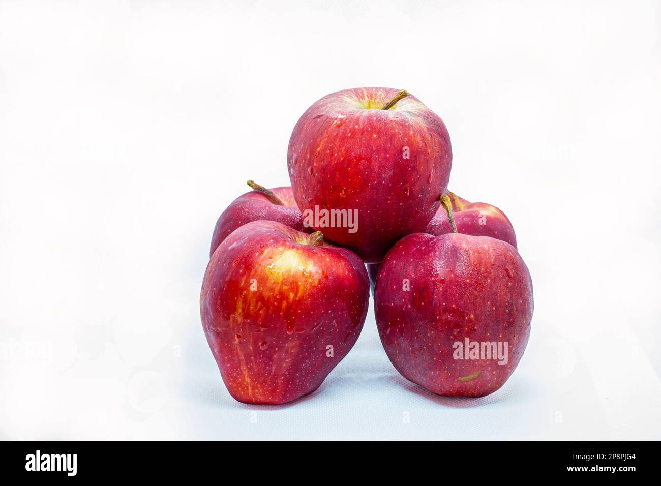 red apples placed on white background Stock Photo - Alamy