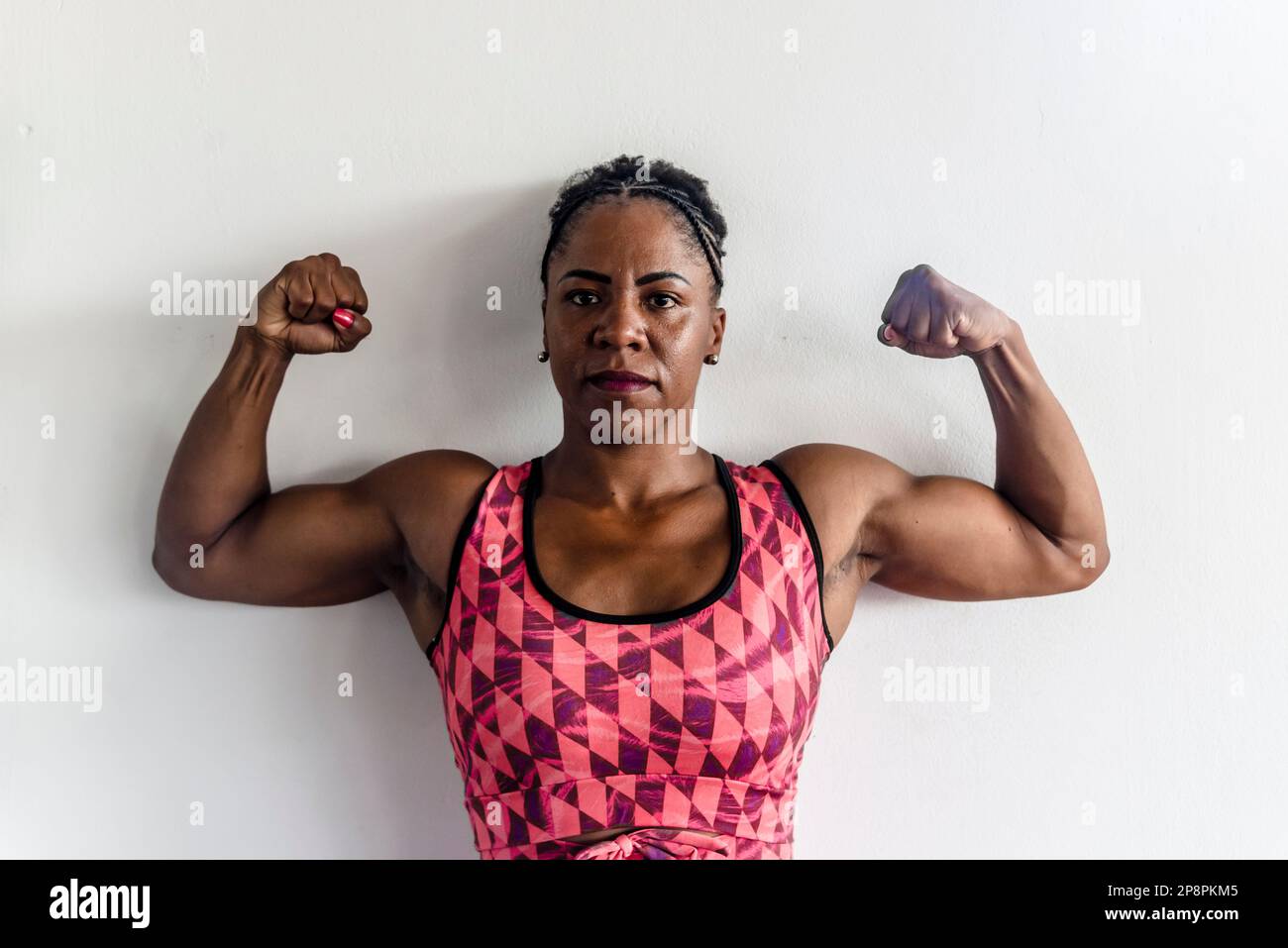 Beautiful woman showing upper muscles. isolated on white background ...
