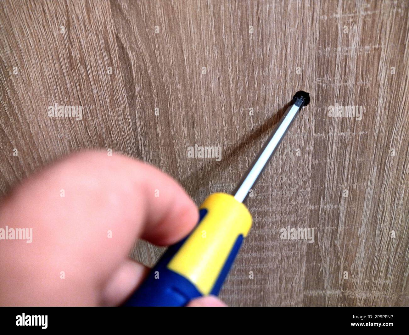 Hand holds screwdriver hi-res stock photography and images - Alamy