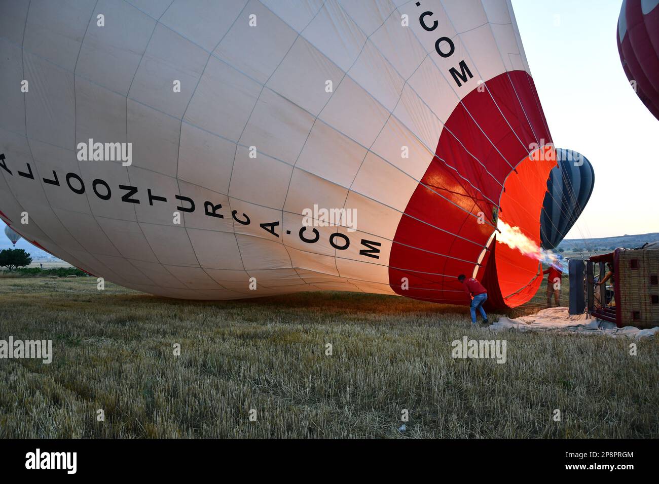 Three men filling a hot air balloon with a large gas burner Stock Photo ...