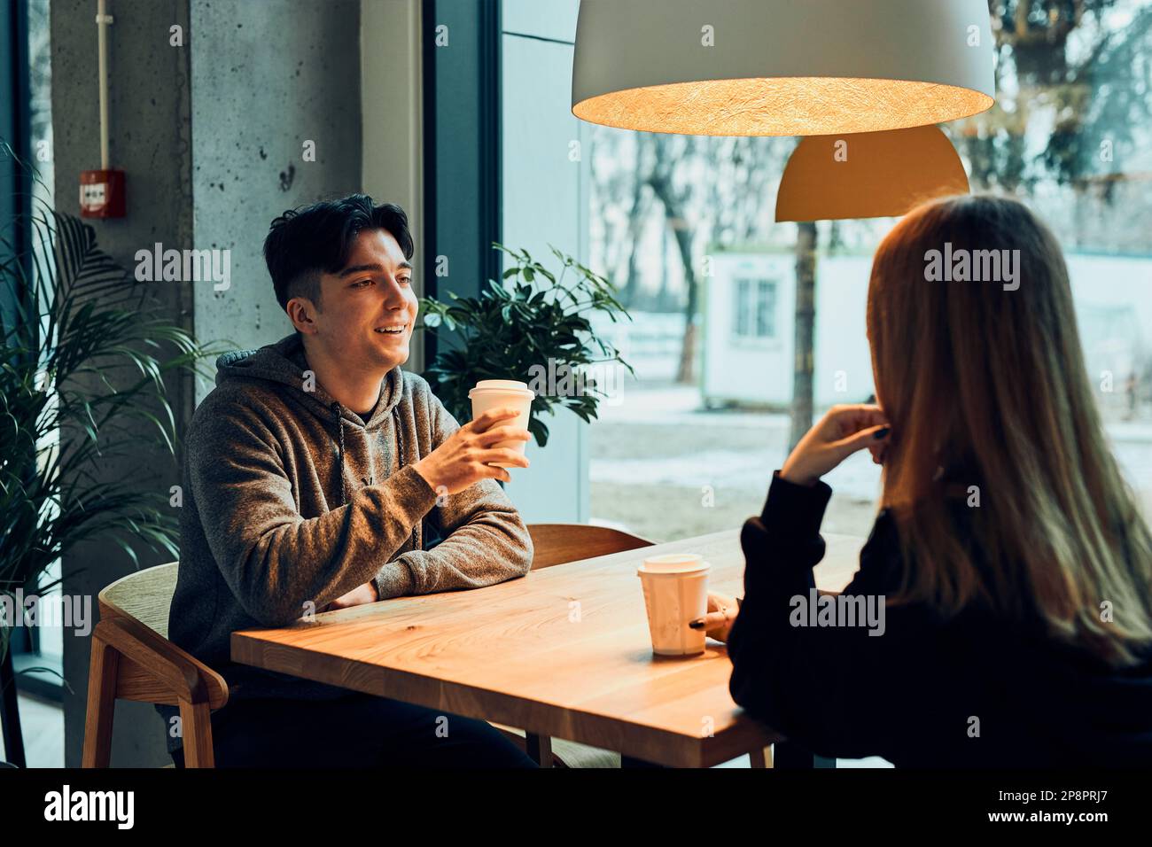 Friends having a chat, talking together, drinking coffee, sitting in a ...