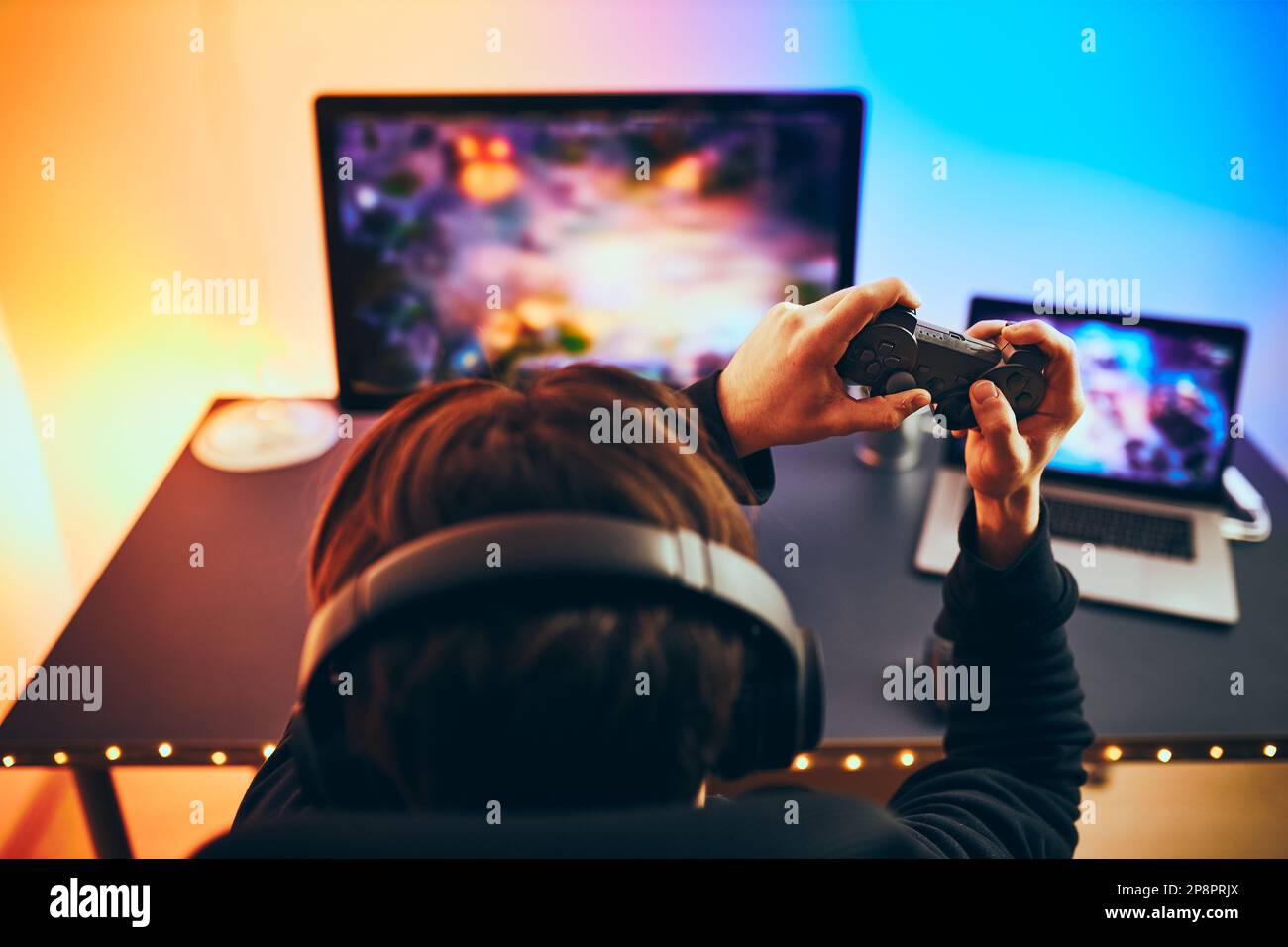 Man playing video game at home. Gamer holding gamepads sitting at front ...