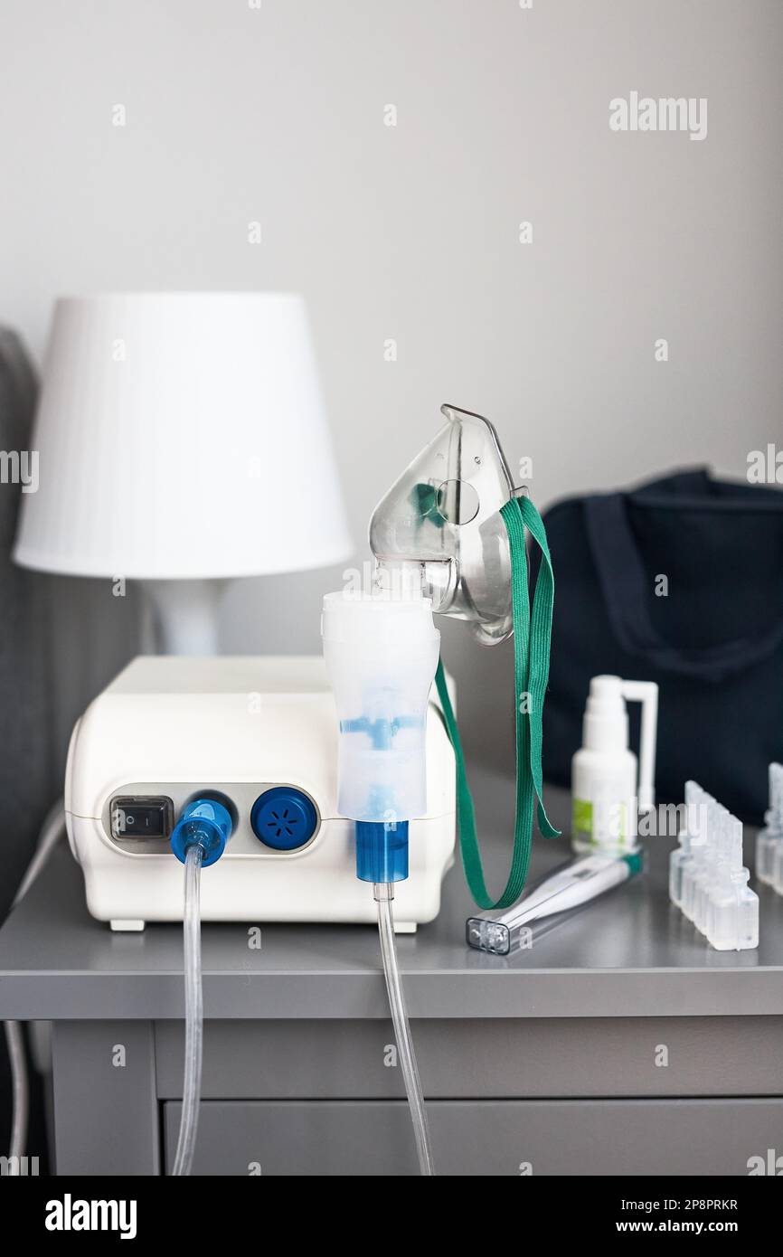 Nebuliser with breathing mask and medicines on bedside table Stock ...