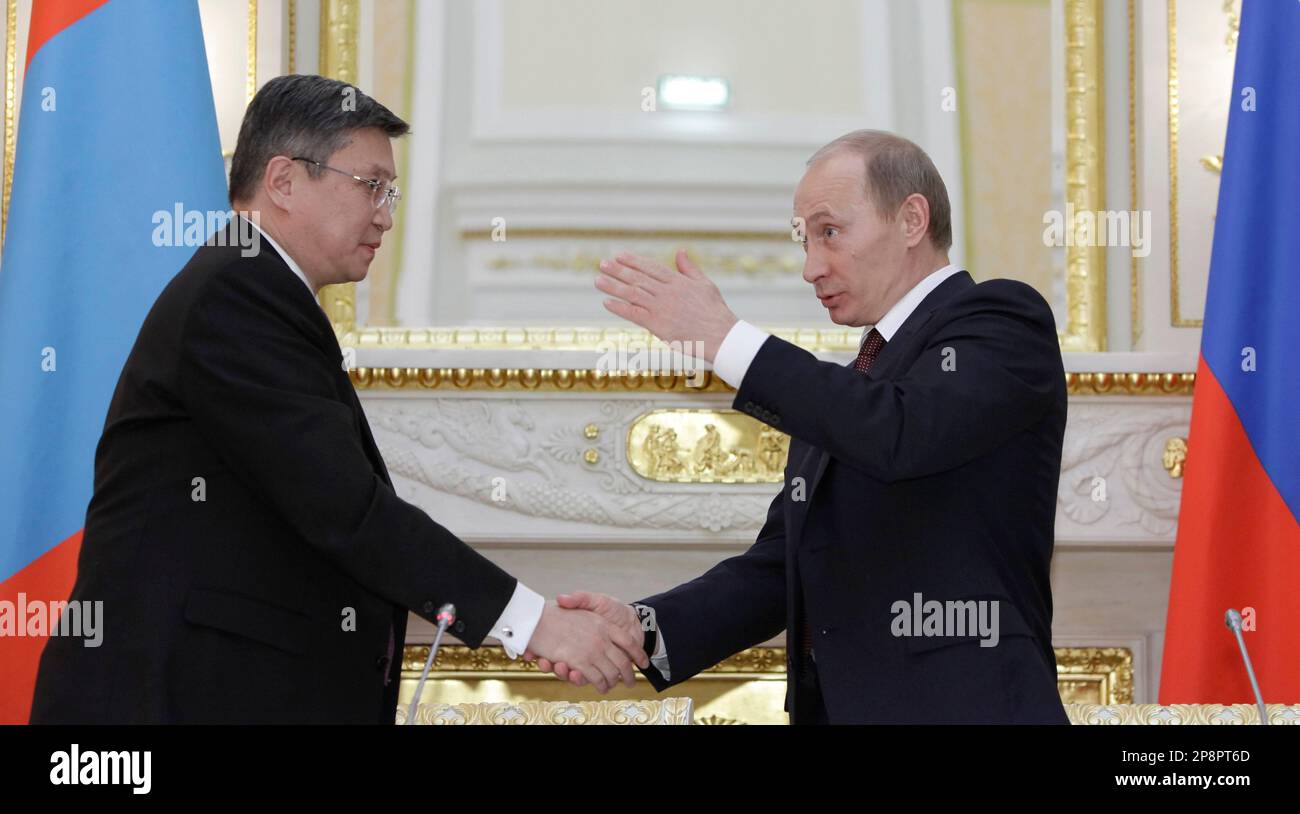 Russian Prime Minister Vladimir Putin, right, shakes hands with his ...