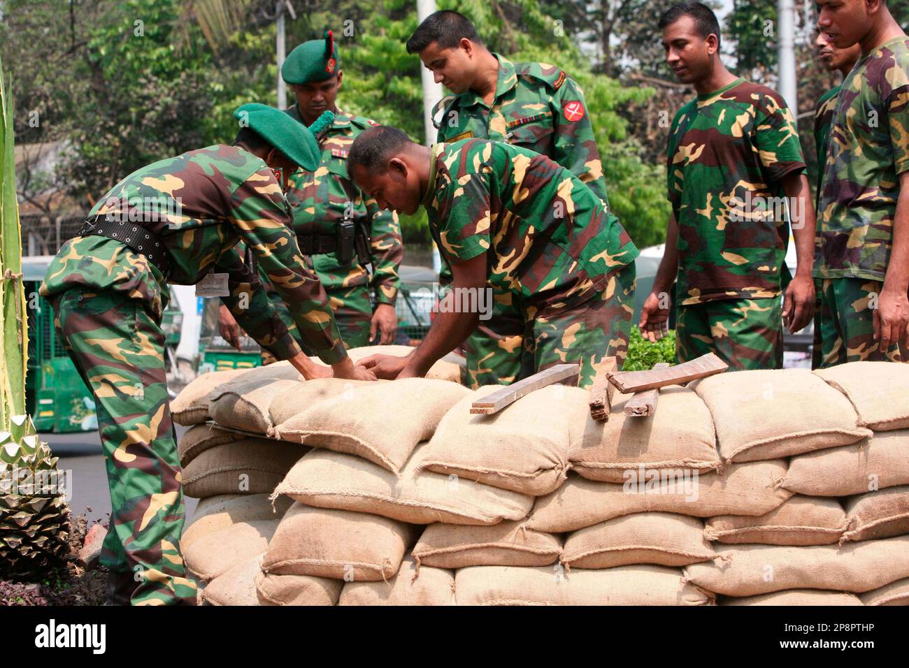 Bangladesh's army soldiers make a temporary check post using sand bags ...