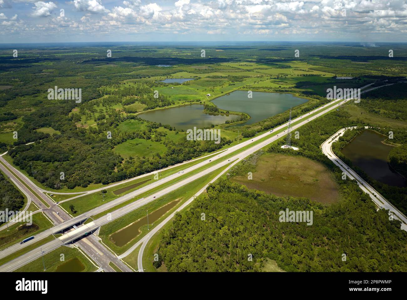 Aerial view of freeway overpass junction with fast moving traffic cars ...