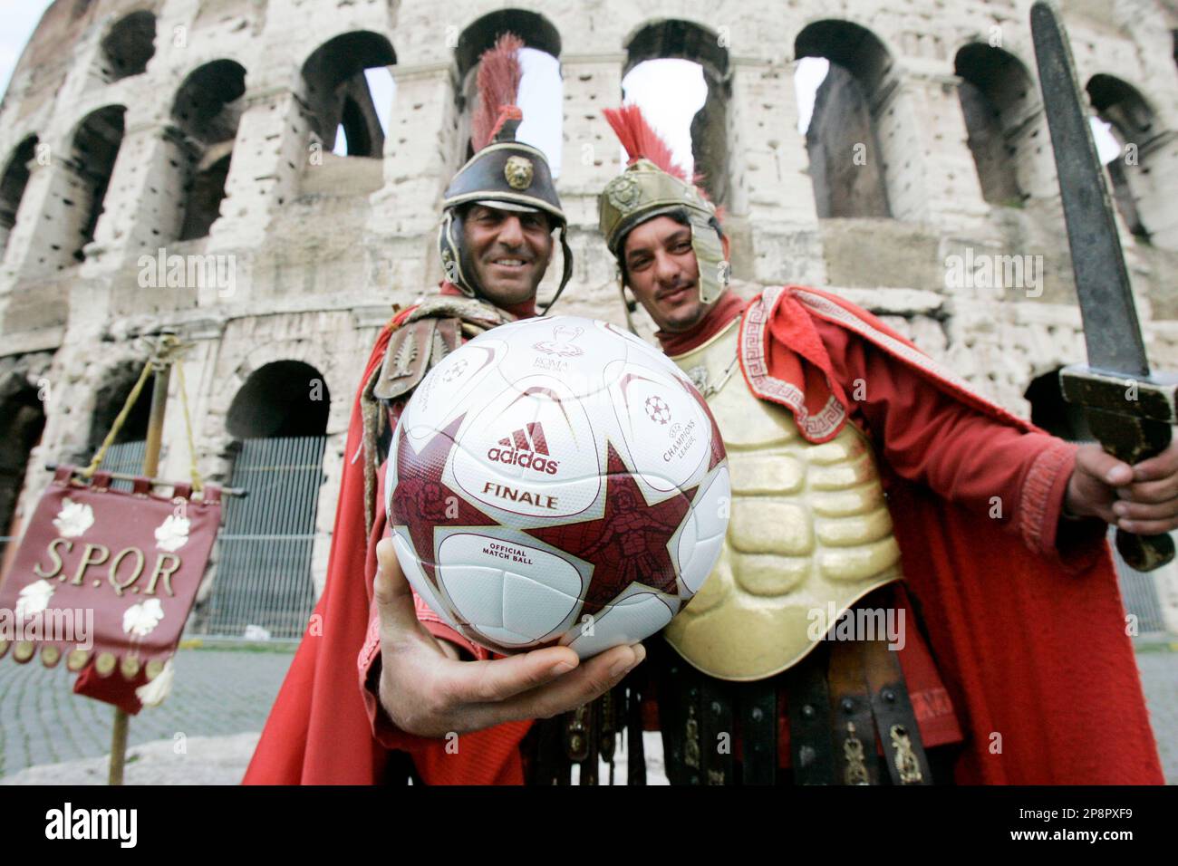 Men wearing Roman centurion costumes hold a replica of the official ...