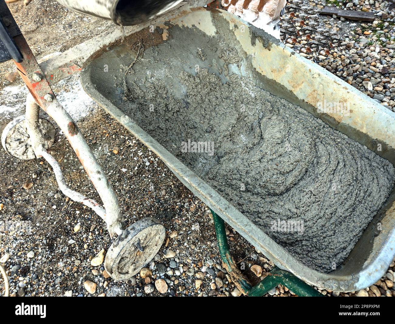 fresh cement in a wheelbarrow Stock Photo - Alamy