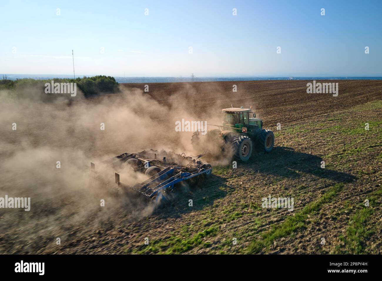 Aerial view of tractor plowing agriculural farm field preparing soil ...