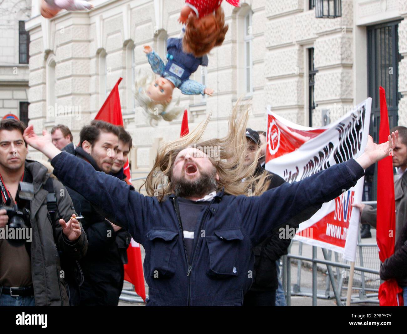A man protests with dolls in front of the court in St. Poelten, Austria ...